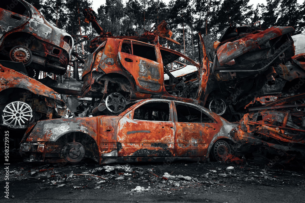Shelled and destroyed rusty civilian cars. Consequences of the military ...