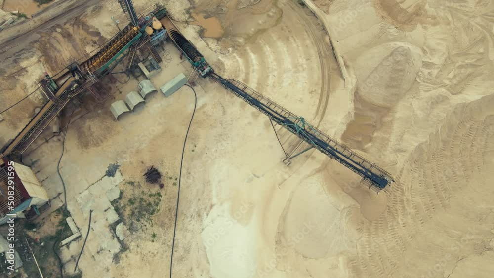 Sand moving on automatic conveyor belt. Mining conveyor sand sorting ...