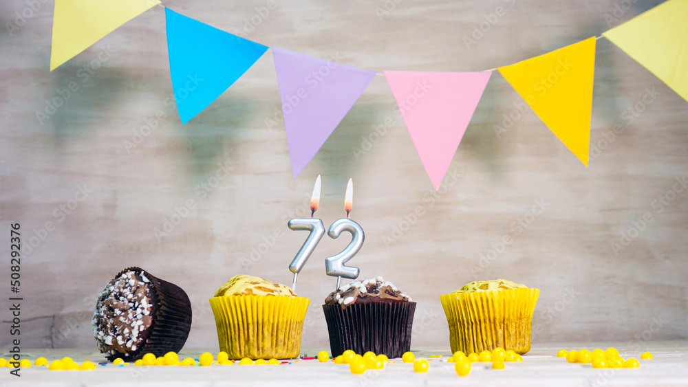 Birthday background with number 72. Beautiful birthday card with colorful garlands, a muffin ...