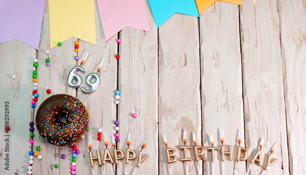 Birthday with number 69. Donut on the festive table. Happy birthday ...
