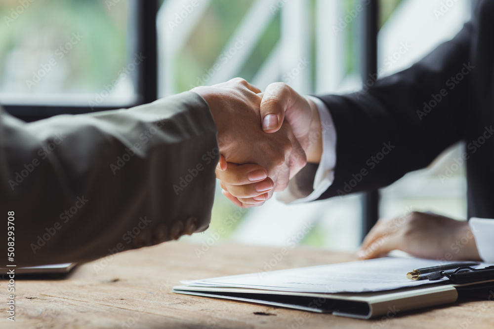 Managers and job applicants shake hands after the interview, resumes ...
