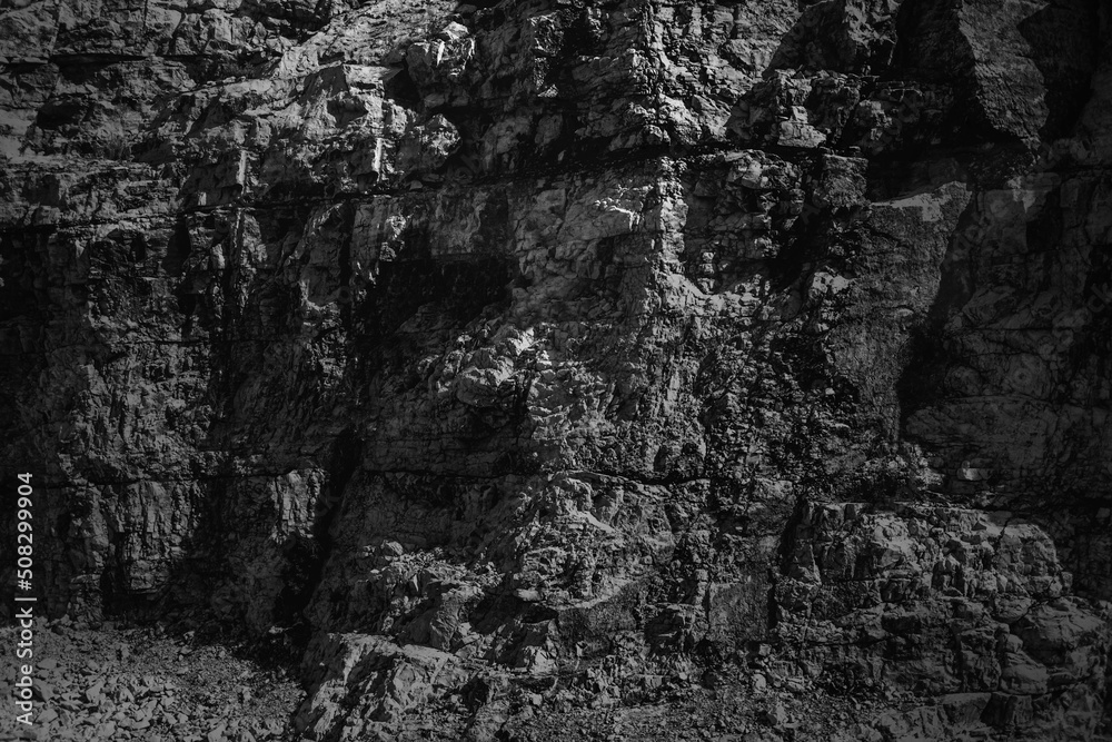 Grungy cragged bumpy pitted cavity stone facade, split layer gap.Ruined ...