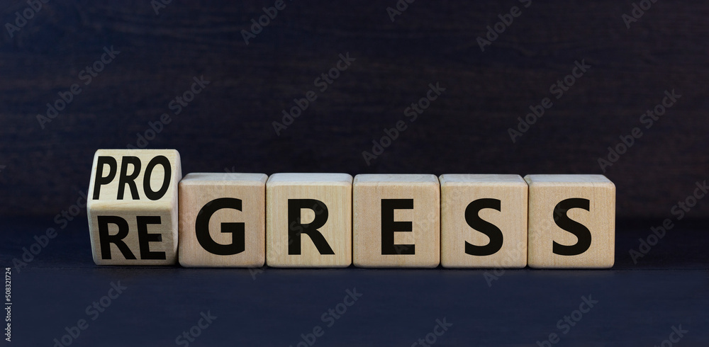 Regress or progress symbol. Turned wooden cubes and changed the word ...