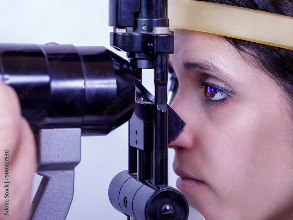 Eye medical examination. Eye doctor visits the patient using a special ...