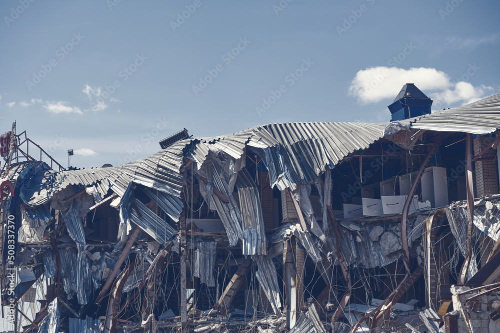 Damaged shop center due to building demolition surrounded with rubble ...