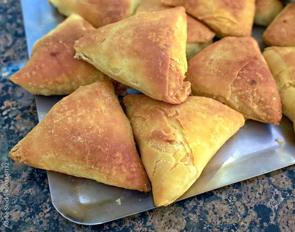 Triangle shaped greek cheese pies top view closeup, made with tasty ...