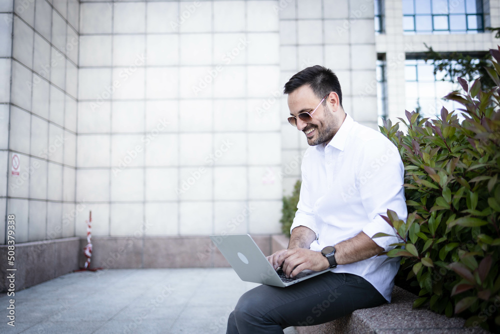 Young and succesfull business man finishing some work online while ...