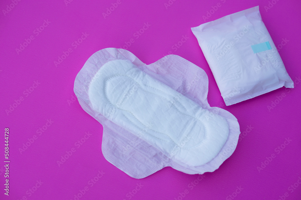 White sanitary pad on pink background. Concept: female's hygienic ...
