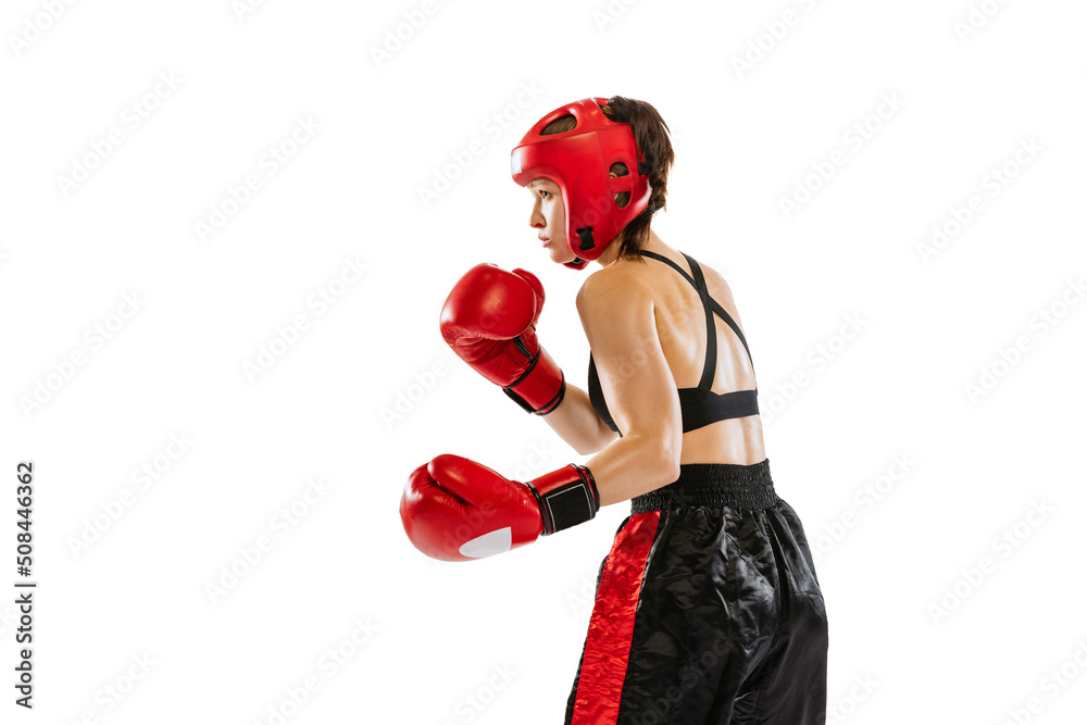 Professional female boxer in boxing gloves and helmet training isolated ...