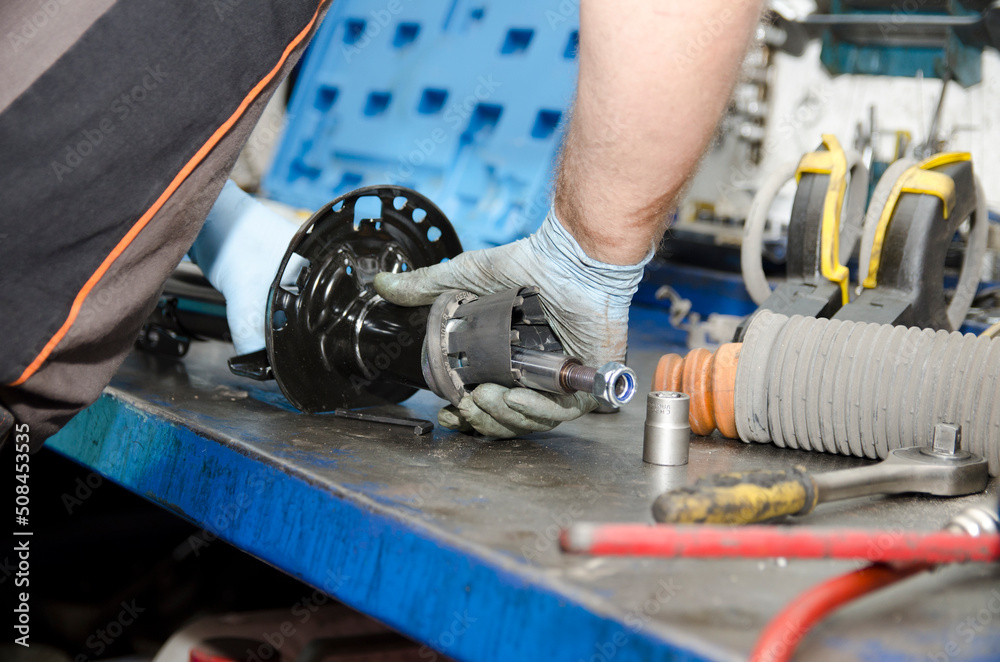 Auto mechanic working on car engine in mechanics garage. Repair service ...