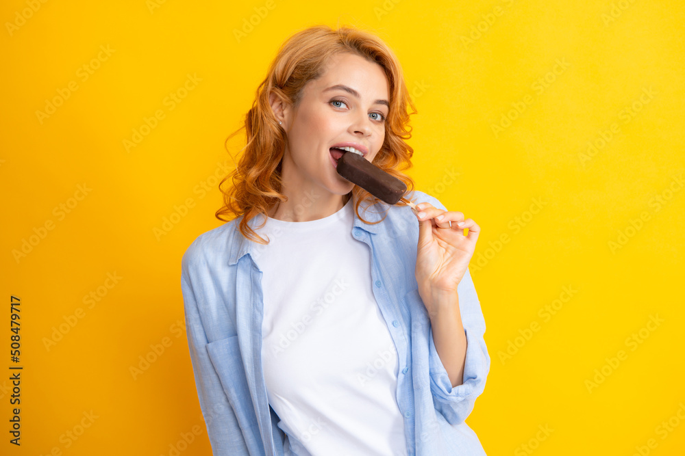 Portrait of beautiful woman eating ice cream on orange yellow ...