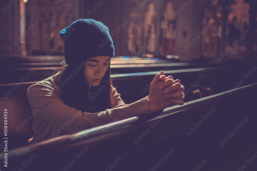 Young woman prayer's pray alone in church, People pray to God with ...