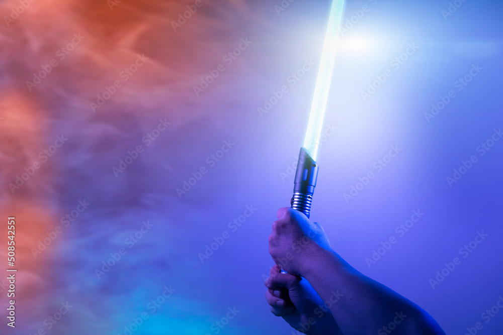 a fantastic laser sword lightsaber in the hands of a man Stock Photo ...