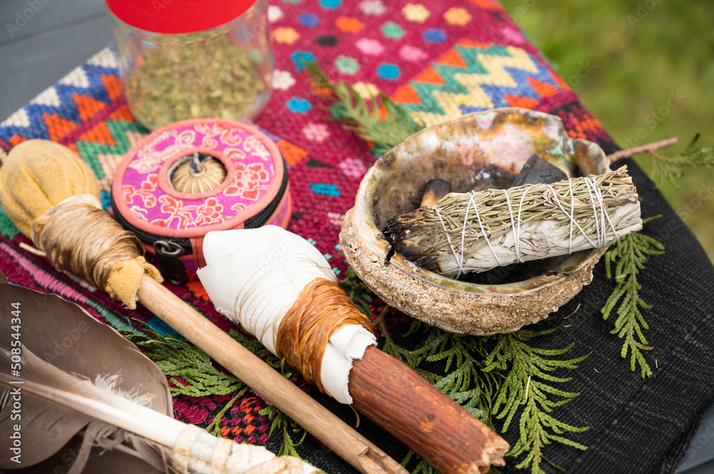 A bundle of sage and an eagle feather are laid out in preparation of a ...