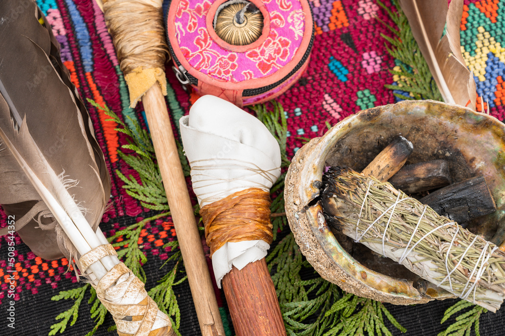 A bundle of sage and an eagle feather are laid out in preparation of a ...