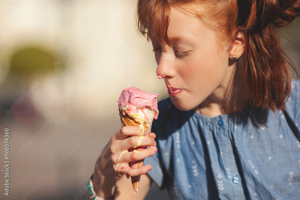 Cute girl eating ice cream on summer background outdoors. closeup ...