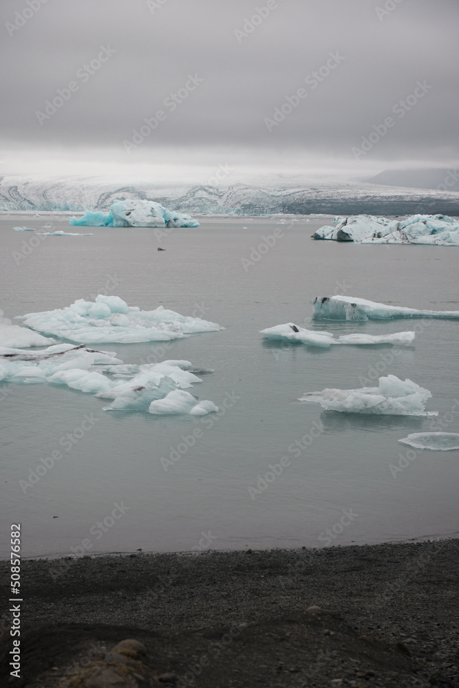 Melting blue ice rocks floating in glacier lake of Jokulsarlon, Iceland ...