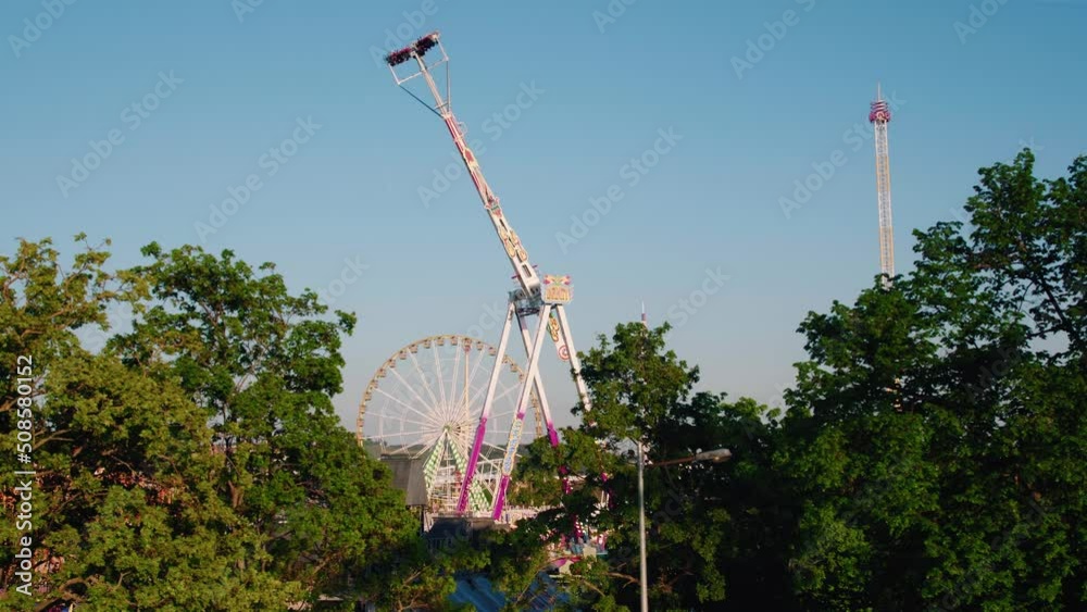 Swing Ride, Ferris Wheel and Free Fall Tower Scenic overview on a clear ...