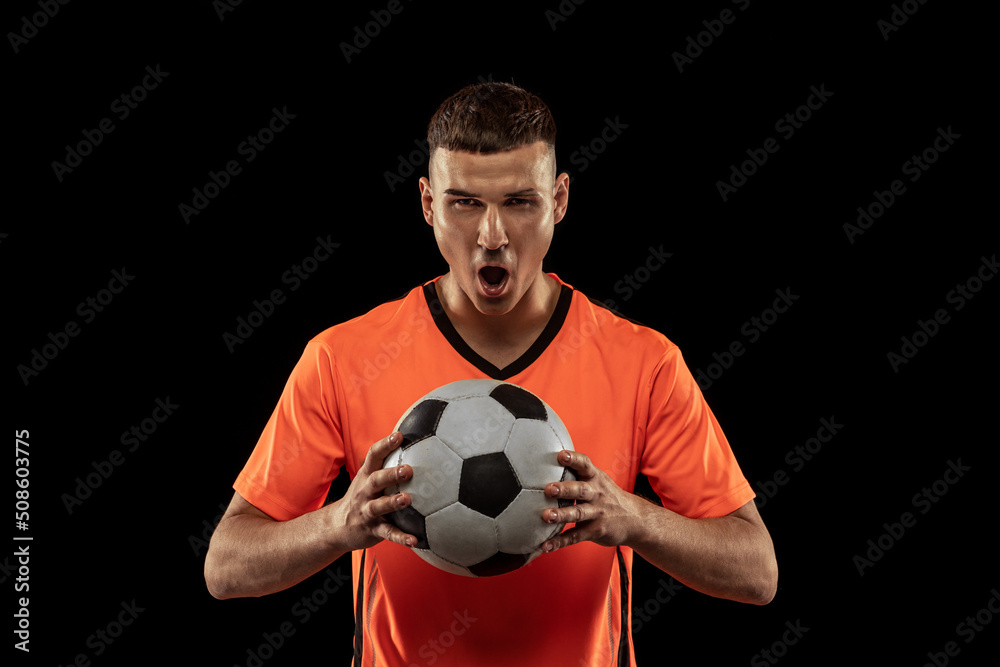 Front camera view of young male soccer player in orange-blue football ...