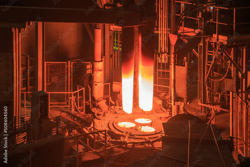 Hot red graphite electrodes in steel mill workshop. Stock Photo | Adobe ...