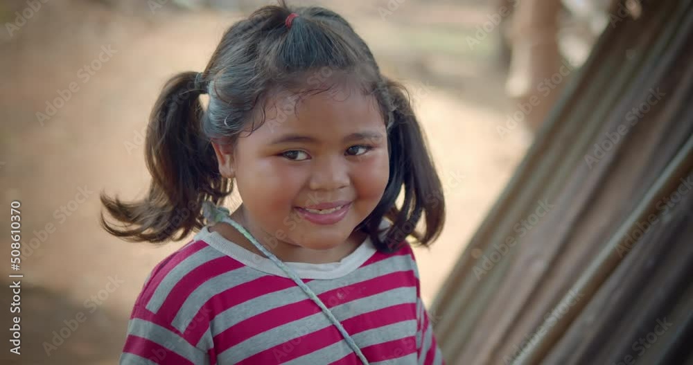 A happy smiling cute little girl who is a daughter of an indigenous ...