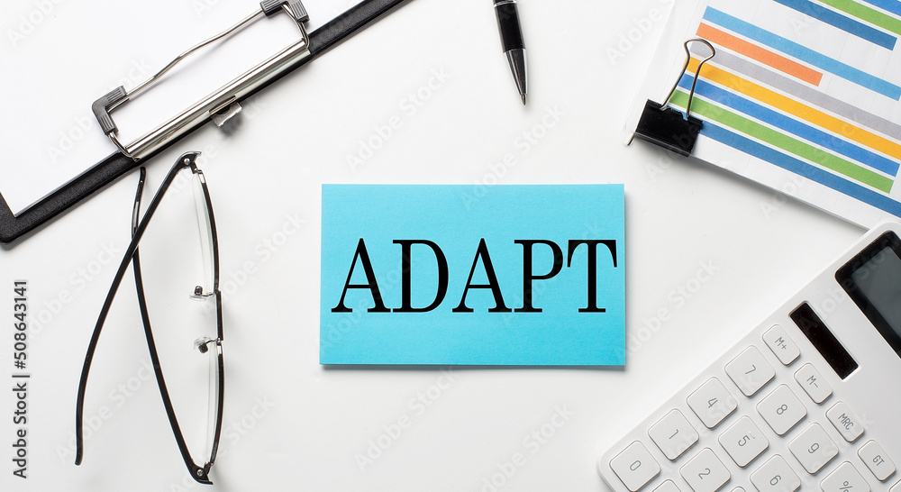 Stickers with chart,calculator and paper with text ADAPT on the white ...