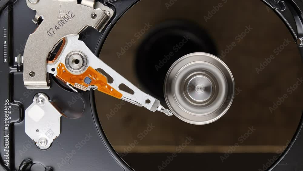 HDD spinning platter stops. Hard disk drive with moving read-write head ...