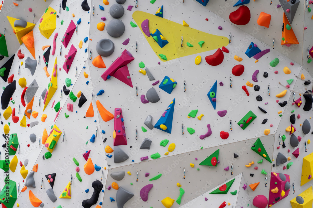 Street artificial rock climbing wall close-up view various colored ...