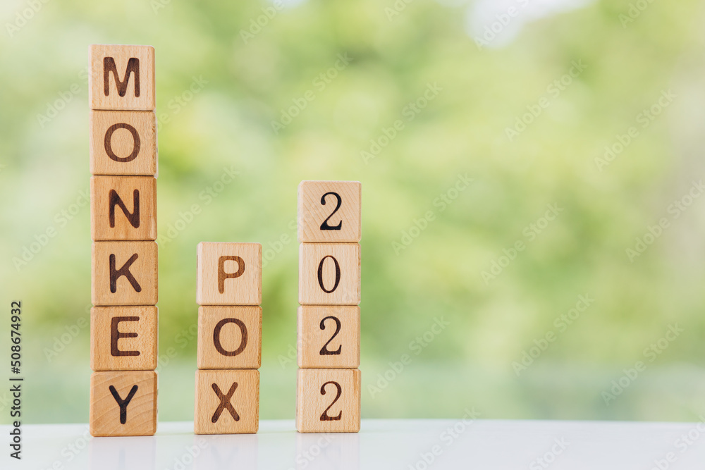 MONKEYPOX. Word written on square wooden tiles with an green background ...