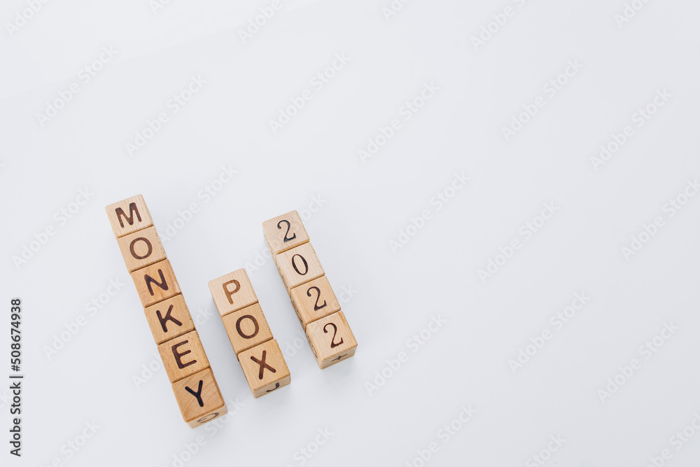MONKEYPOX. Word written on square wooden tiles with an white background ...