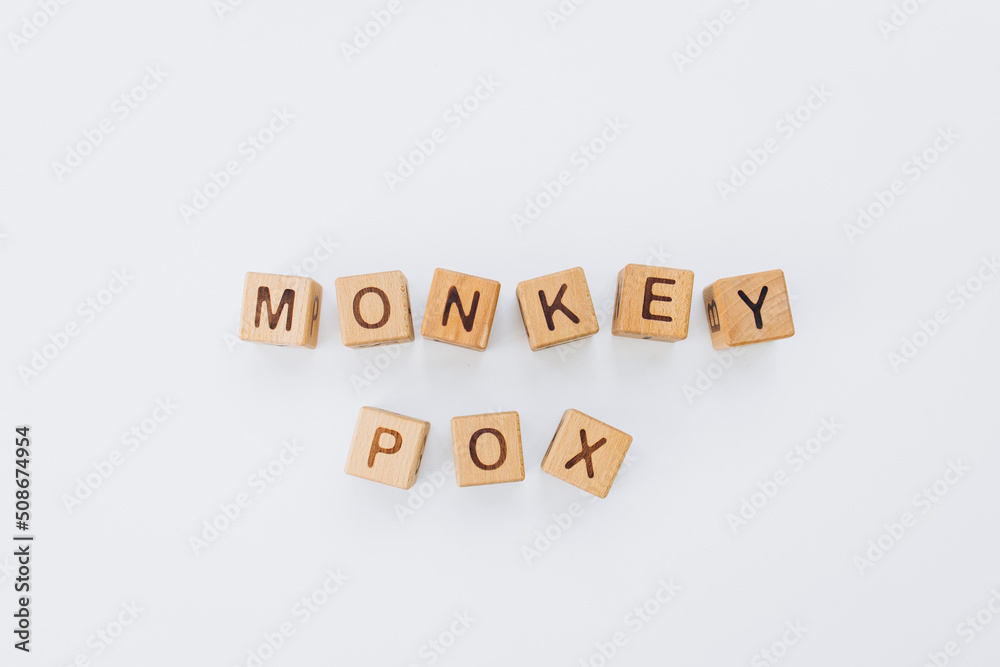 Foto de MONKEYPOX. Word written on square wooden tiles with an white ...