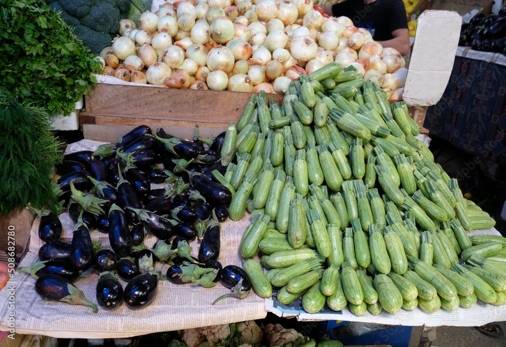 A pile of green and purple squashes on stall in Amman market, Jordan ...