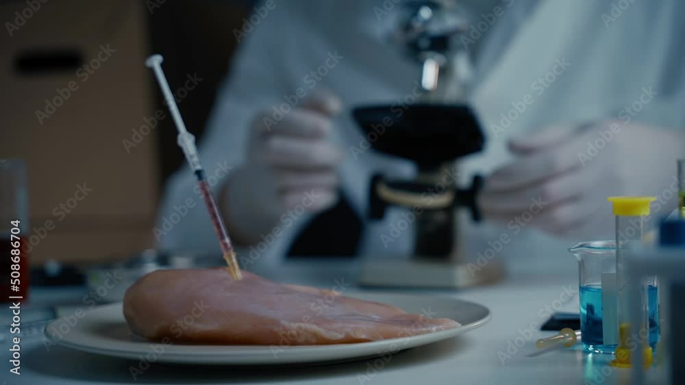 Food quality control scientist works with microscope in laboratory ...