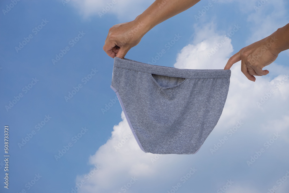 Man's hand hold old and torn underwear pants from long time wearing ...