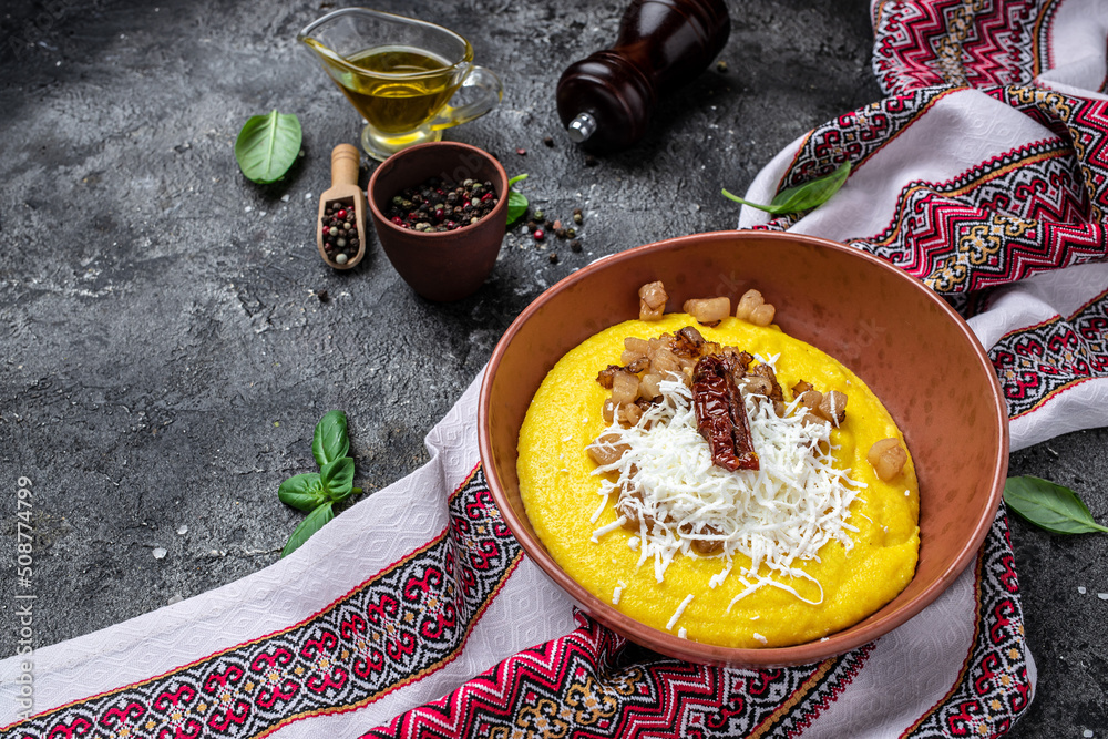 Traditional Ukrainian banosh with corn porridge cheese and lard on a ...