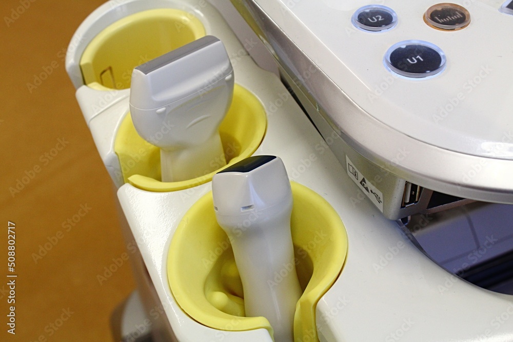 Modern linear and phased array probe placed in side holder of medical ...
