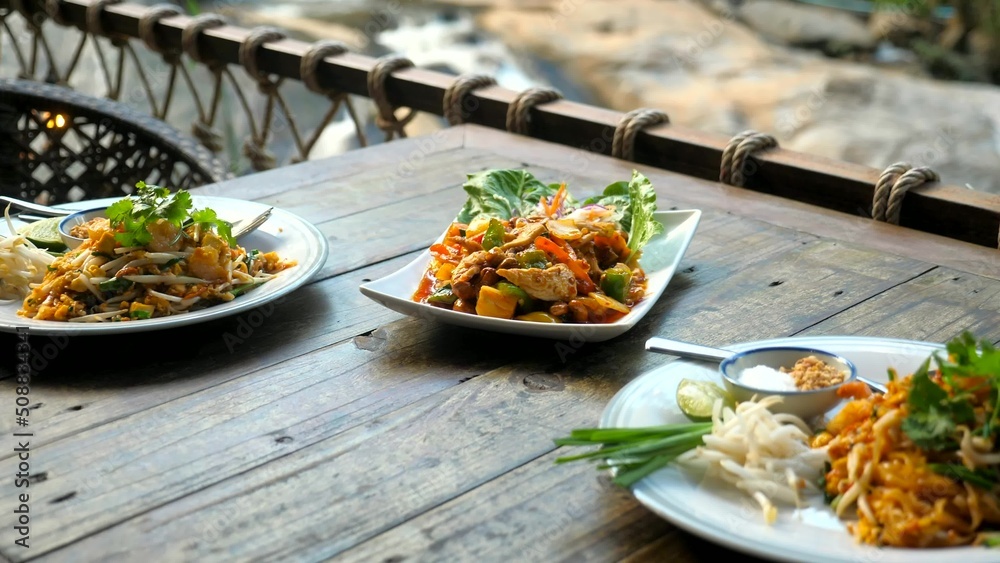 Thai traditional food in outdoor cafe. Shrimp Pad Thai, rice noodle ...