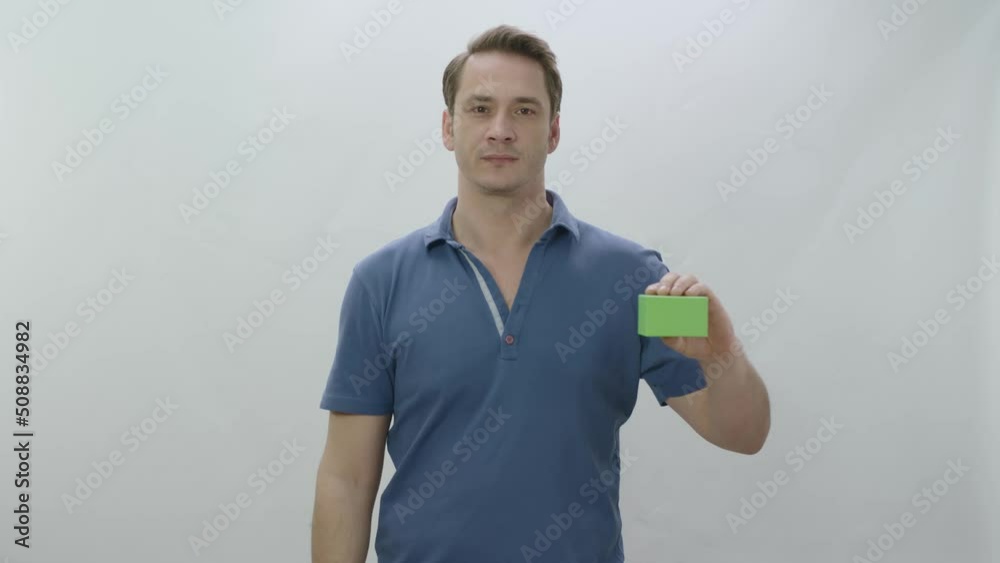 Studio portrait of young man isolated on white background. Man holding ...