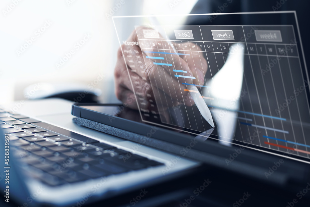 Project manager updating tasks and milestones progress planning using ...