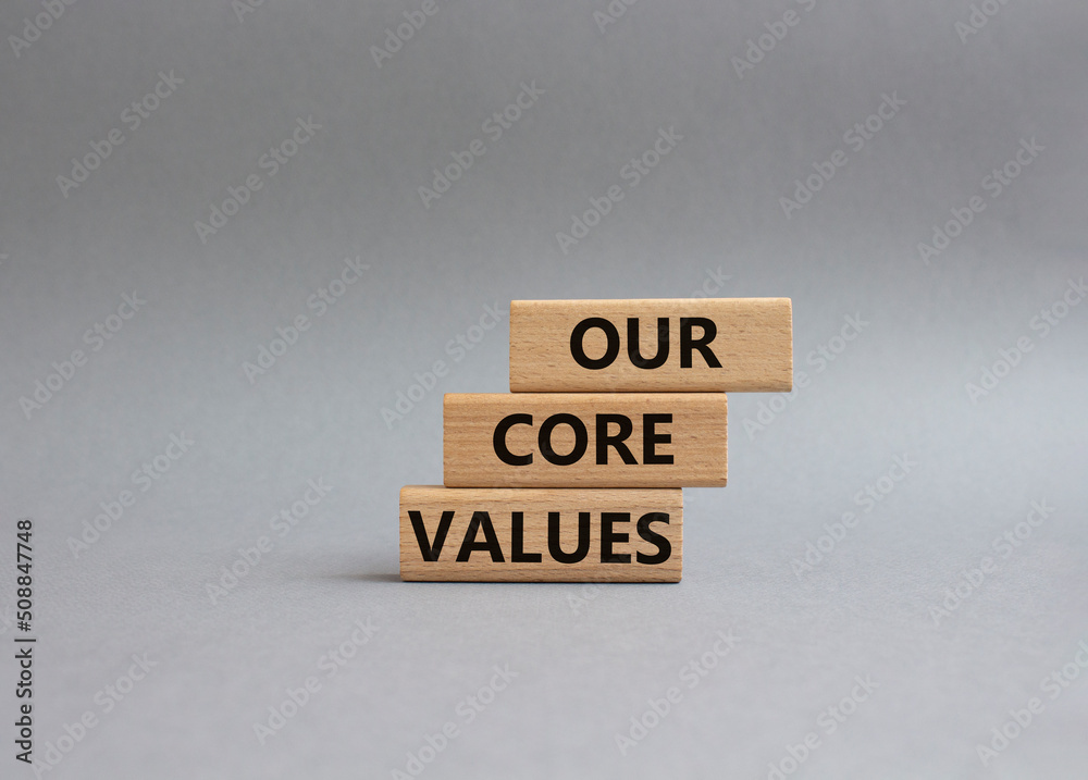 Our core values symbol. Concept words 'Our core values' on wooden blocks. Beautiful grey ...