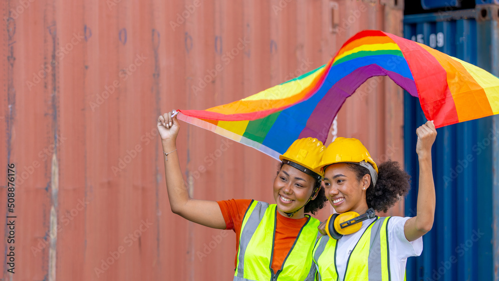 Young female African sisters in safety uniform and helmet show LGBT ...