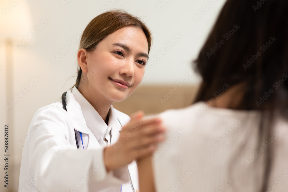 Asian female doctor giving hope and encourage to stressed woman patient ...