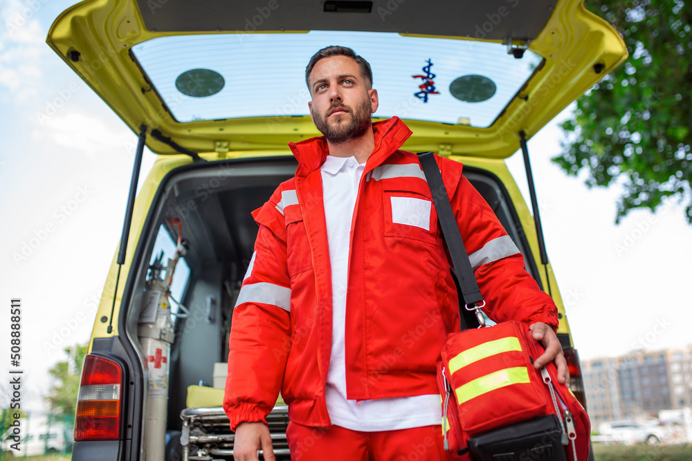 Ambulance staff member emerges from the back of an ambulance with his ...