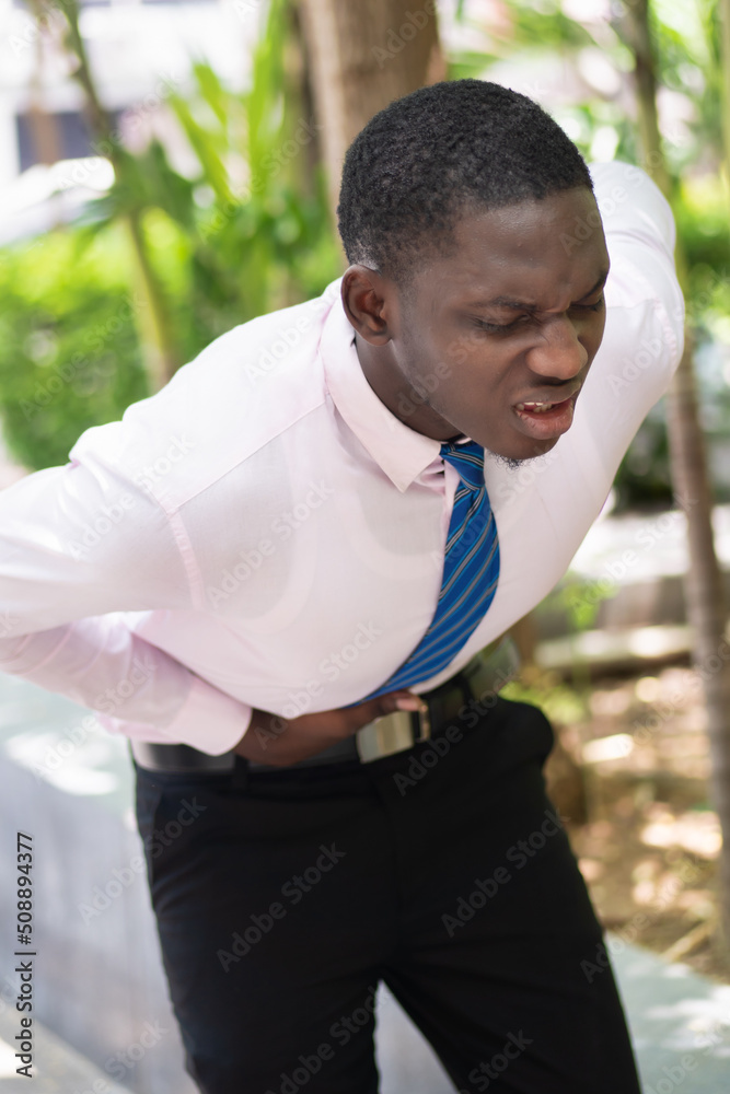 African man with stomach ache, overworked African office worker ...