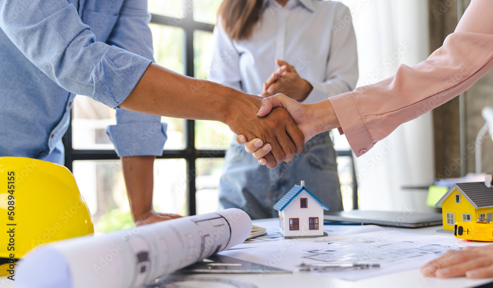 Architect and engineer construction workers shaking hands after ...