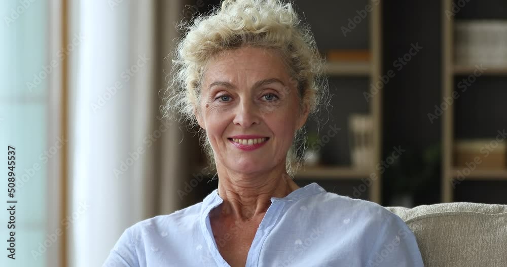 Head shot close up beautiful middle-aged woman smile staring at camera ...