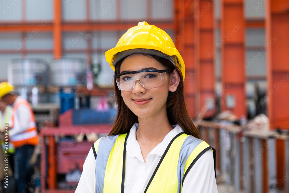 Selective focus at young women inspector wearing safety equipment ...