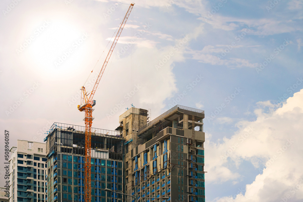 the tower crane at the construction site and heavy equipment for ...