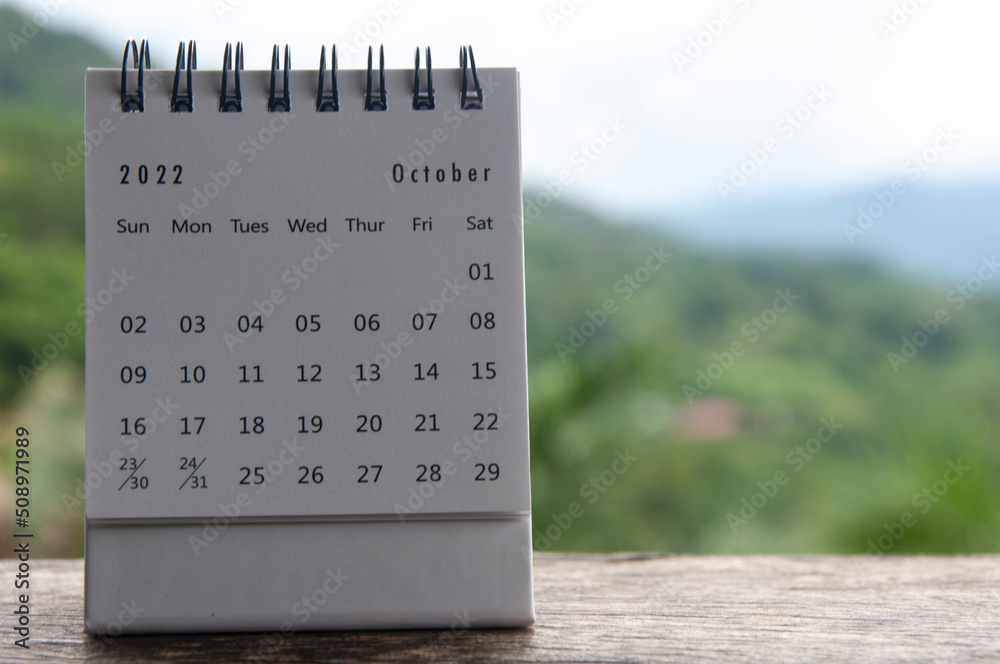 October month calendar with blurred nature background. Copy space and ...