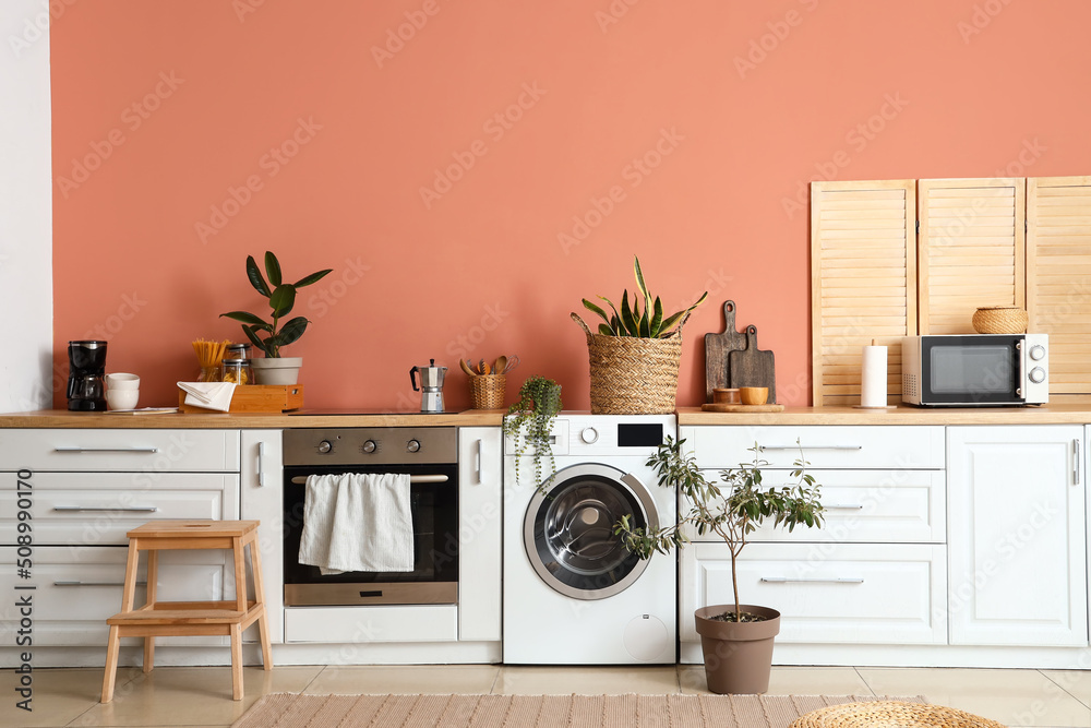 Stylish interior of kitchen with modern washing machine Stock Photo ...